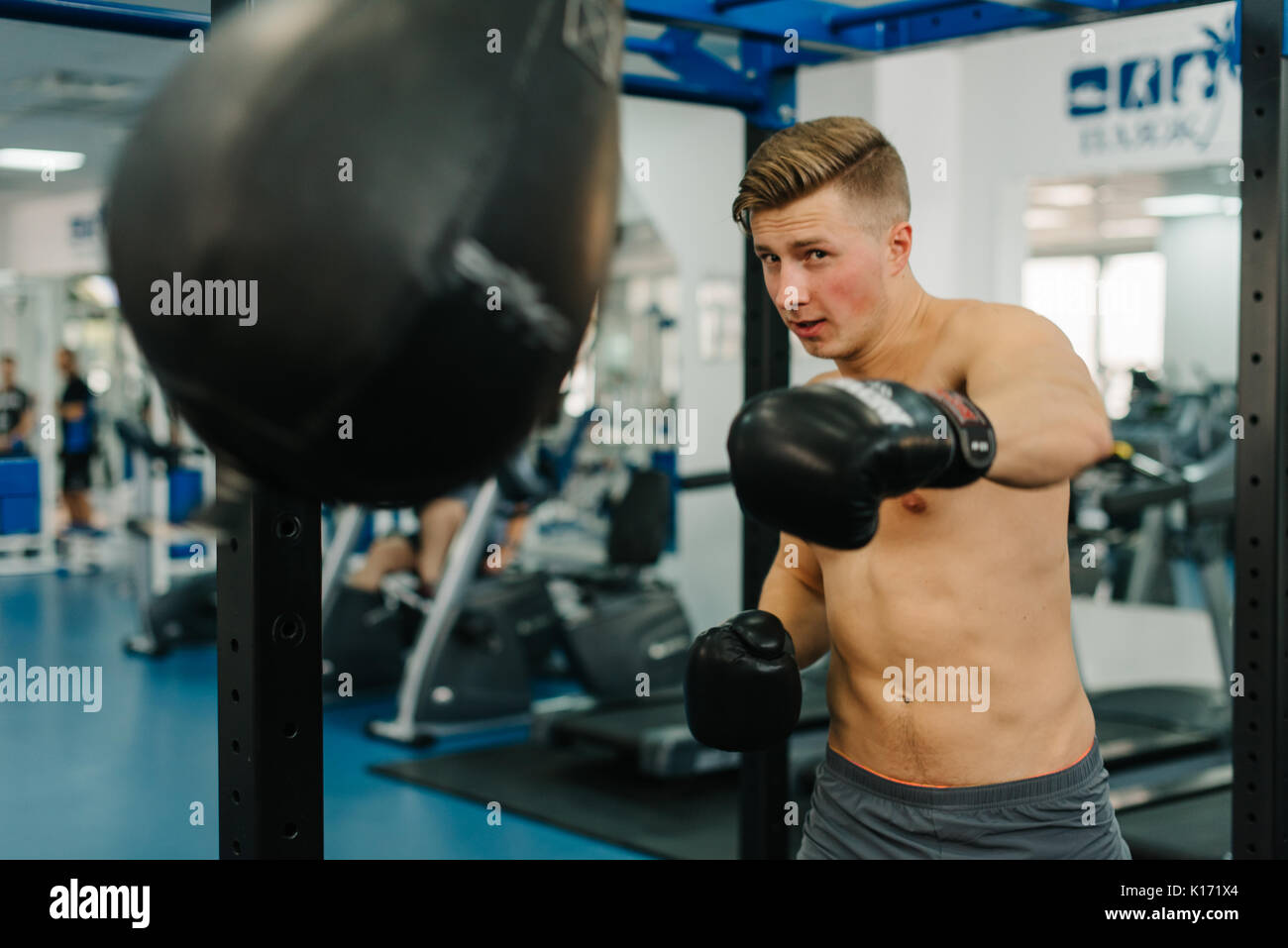 young boxer boxing a punching bag in gym Stock Photo - Alamy