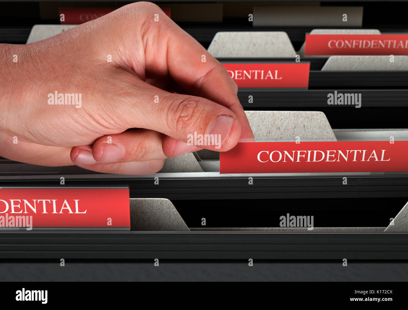 A male hand searching through confidential related documents in a ...