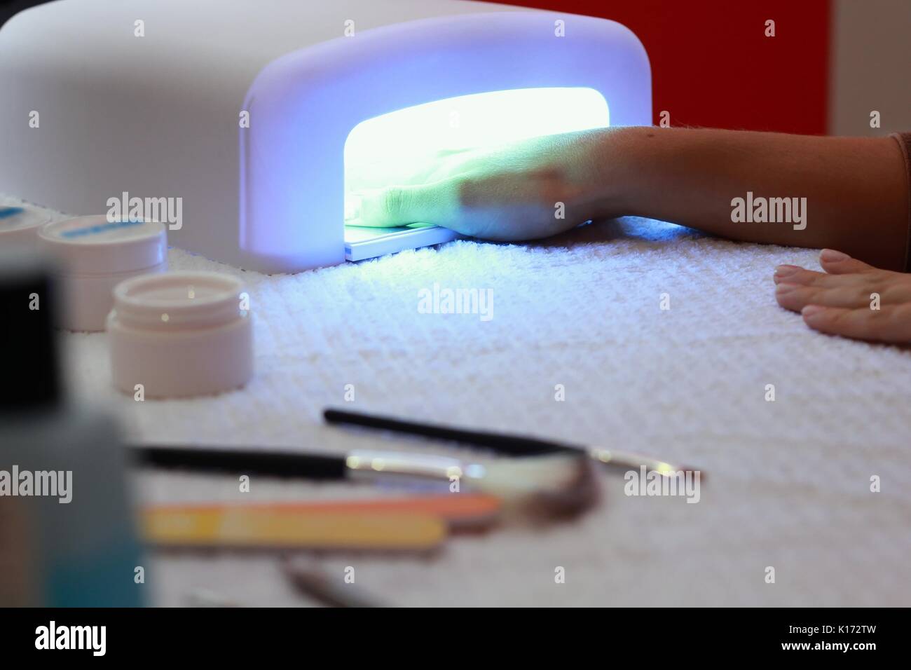 Hand under UV lamp Stock Photo - Alamy