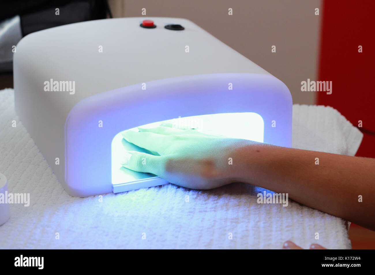 Hand under UV lamp Stock Photo - Alamy