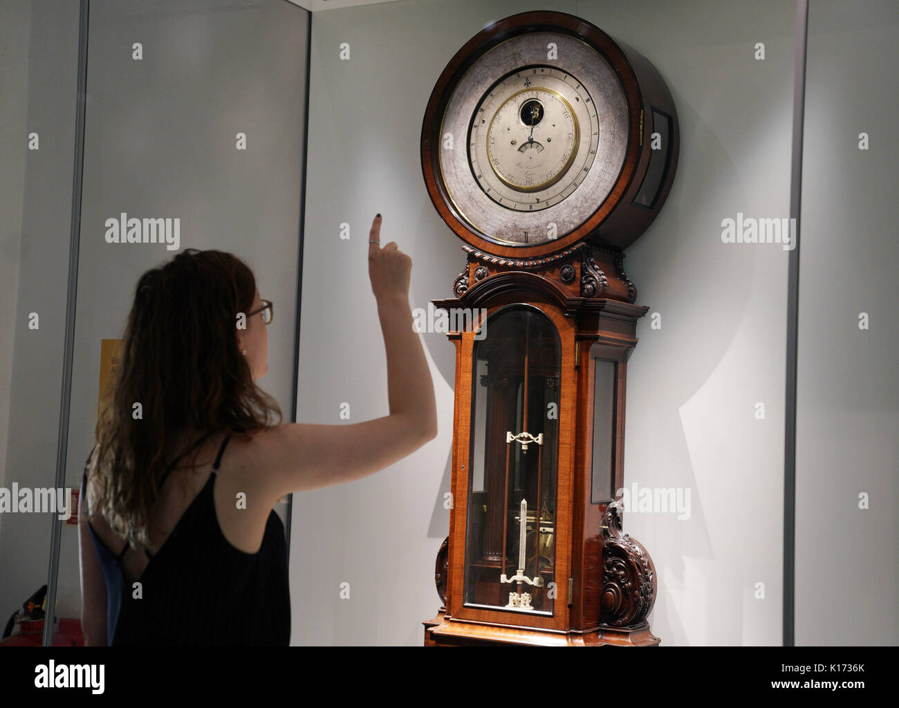 A woman points to Alexander Cumming’s Barograph Clock - which dates ...