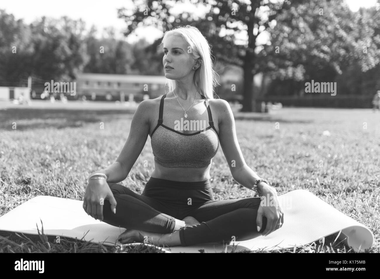 Black and white photo of sports woman sitting on rug Stock Photo - Alamy