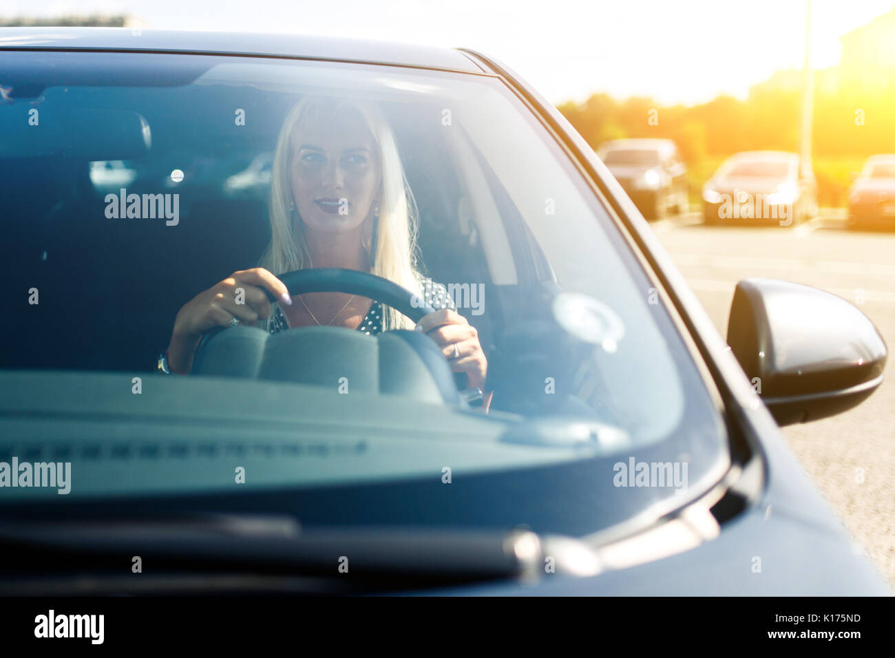 Image of blonde driving car Stock Photo - Alamy
