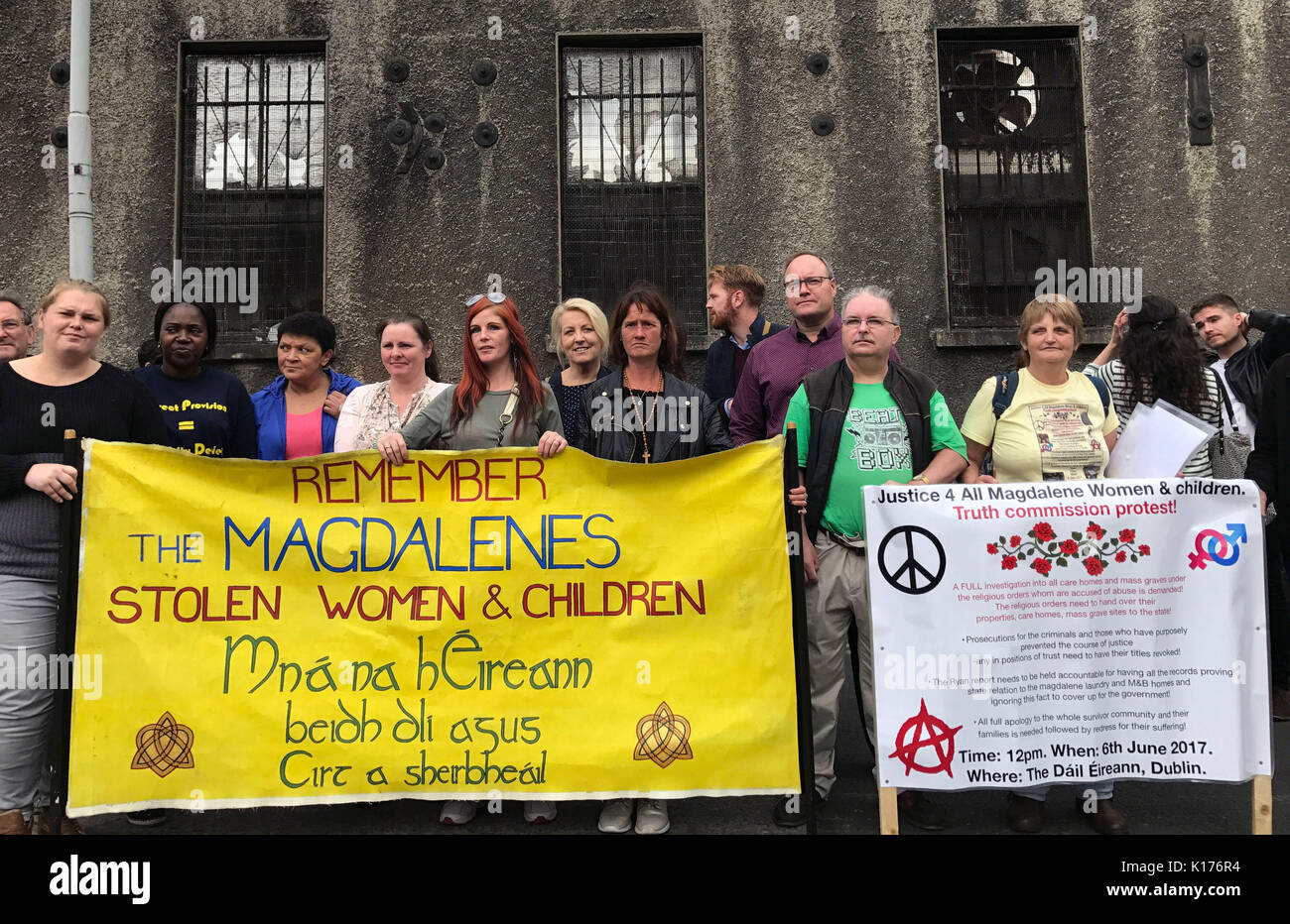Campaigners and survivors of Catholic-run institutions at the back wall ...