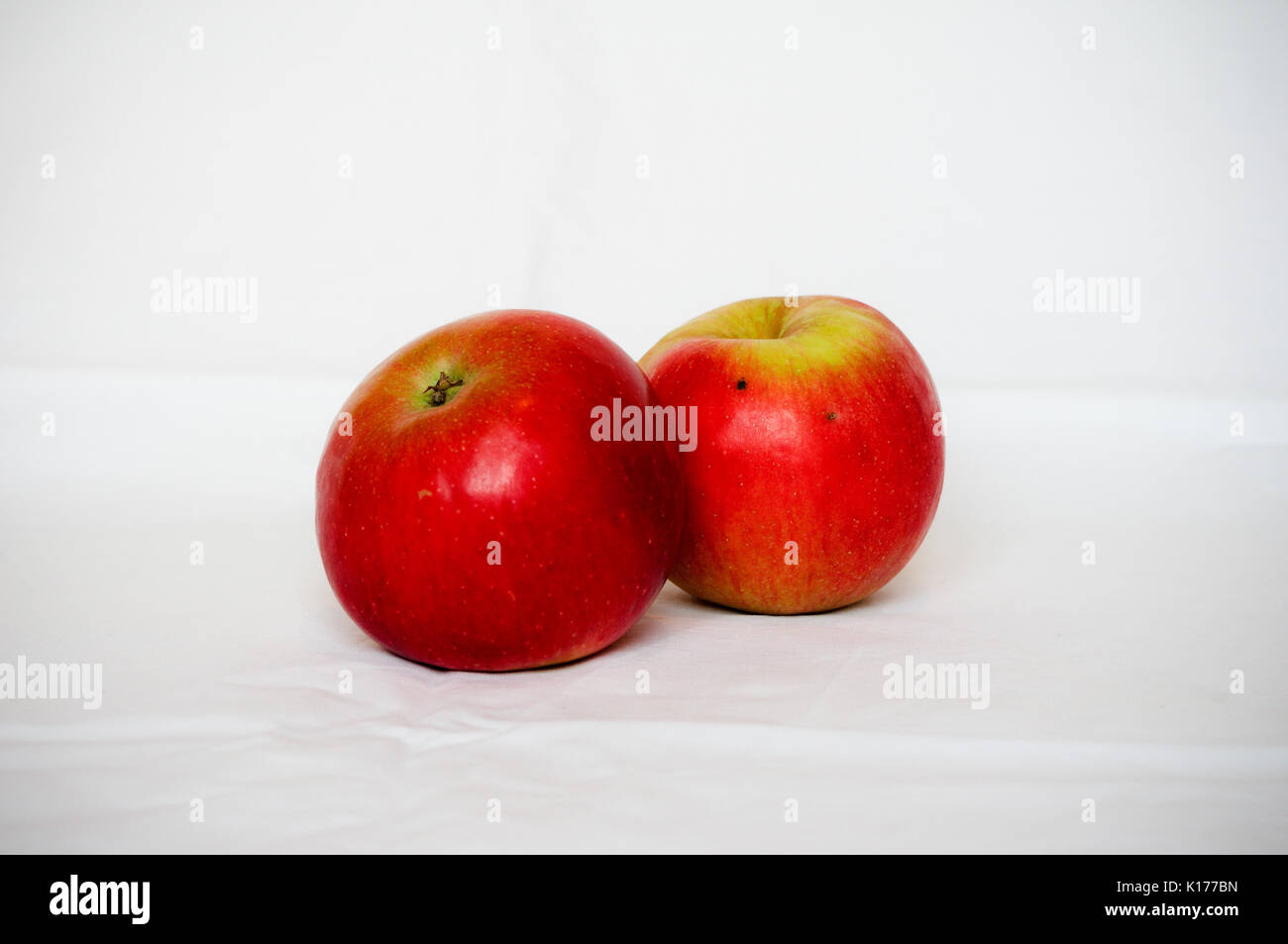 Two red apples on white background Stock Photo - Alamy