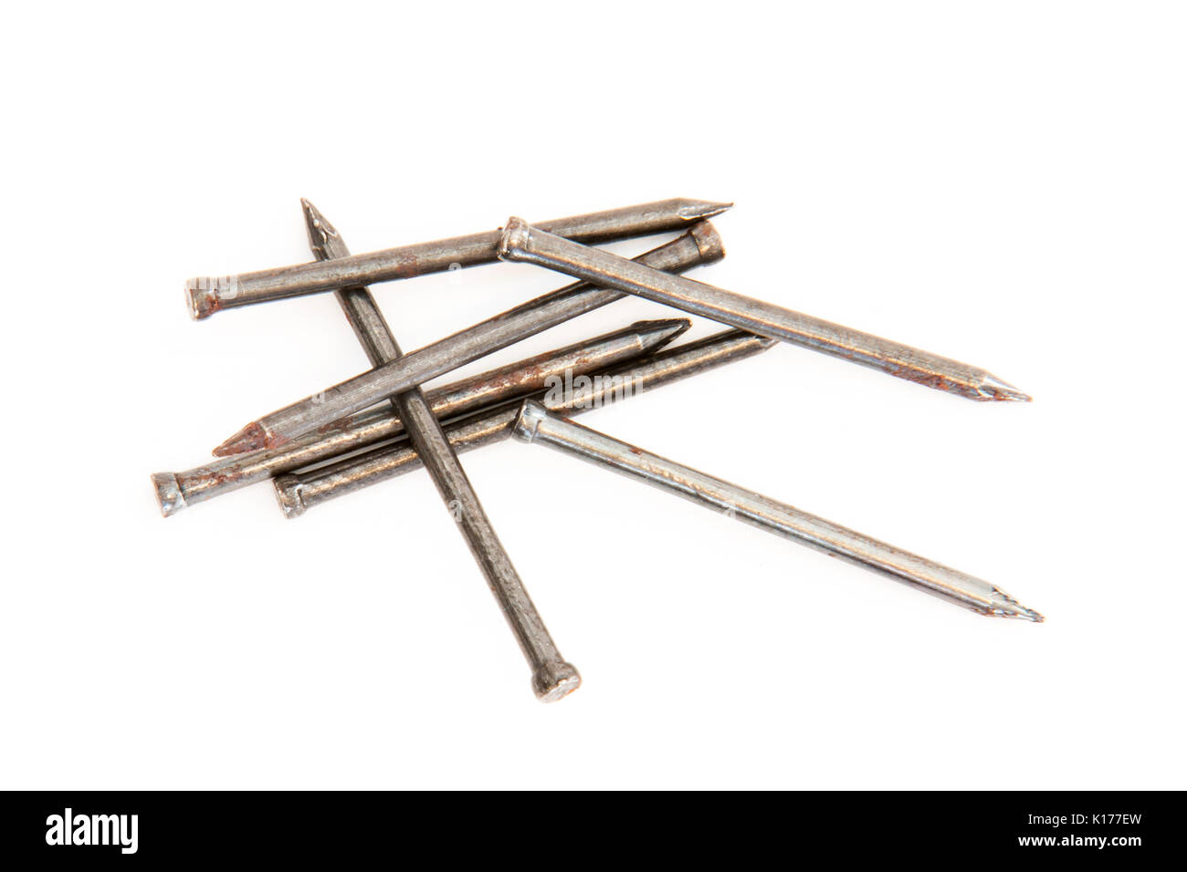 Pile of 7 nails on a white background Stock Photo - Alamy