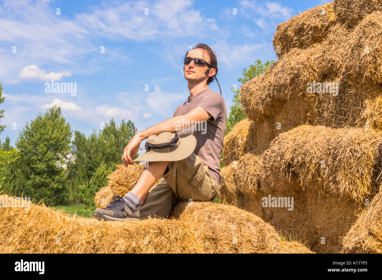 Male sitting on a hay bale hi-res stock photography and images - Alamy