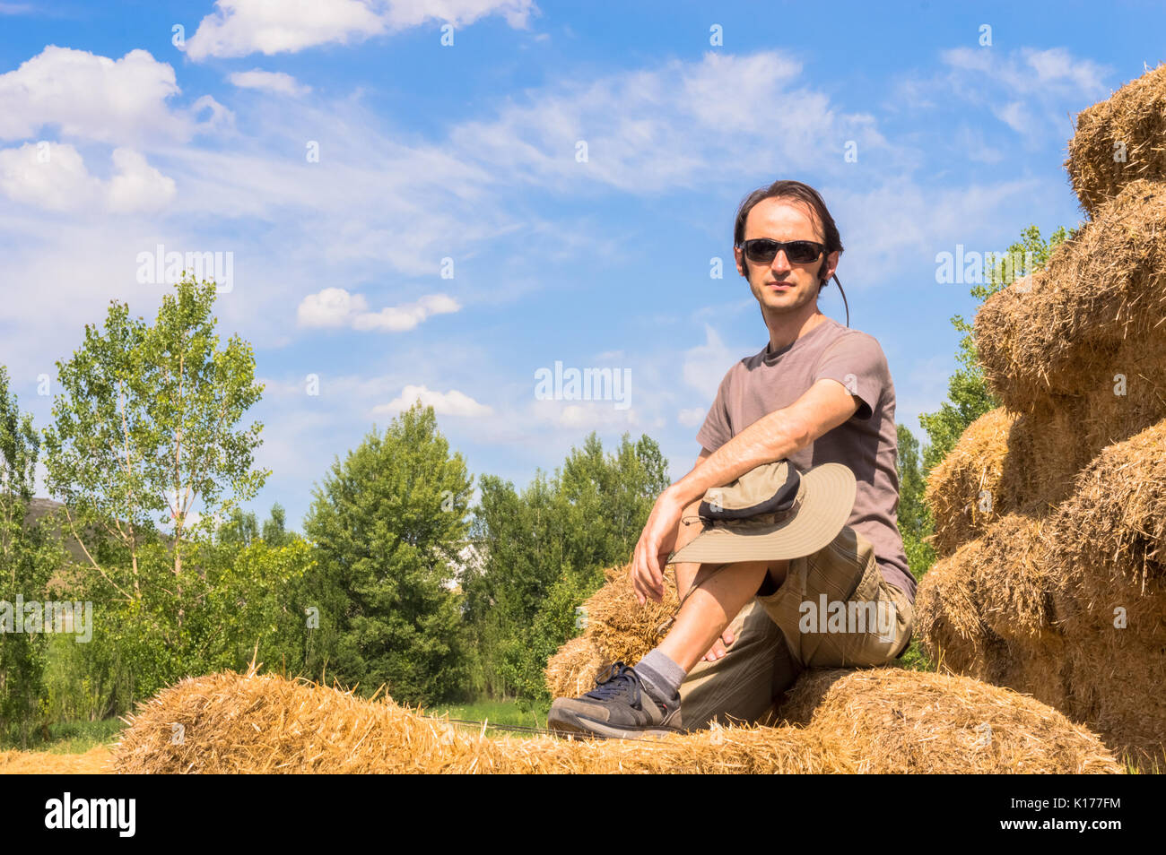Man sitting on hay bale hi-res stock photography and images - Alamy