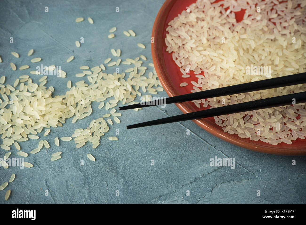 Porcelain plate and rice on grey concrete table with copyspace Stock ...