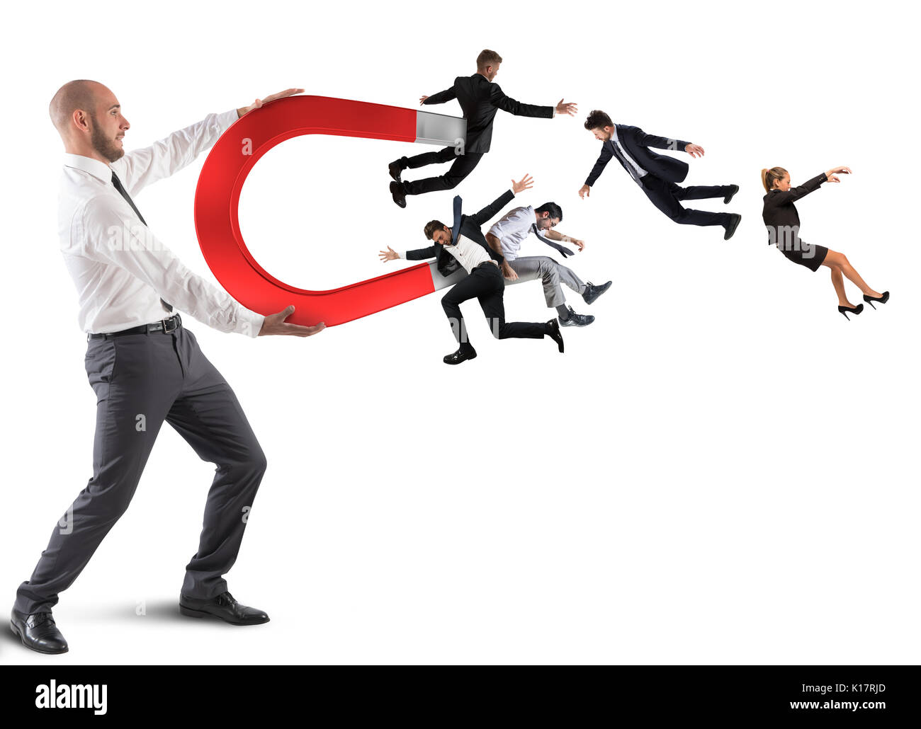 Businessman attracts people with a big magnet Stock Photo - Alamy