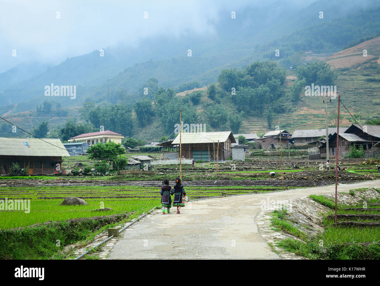 Sapa, Vietnam - May 30, 2016. Hmong girls walking on rural road in Sapa ...
