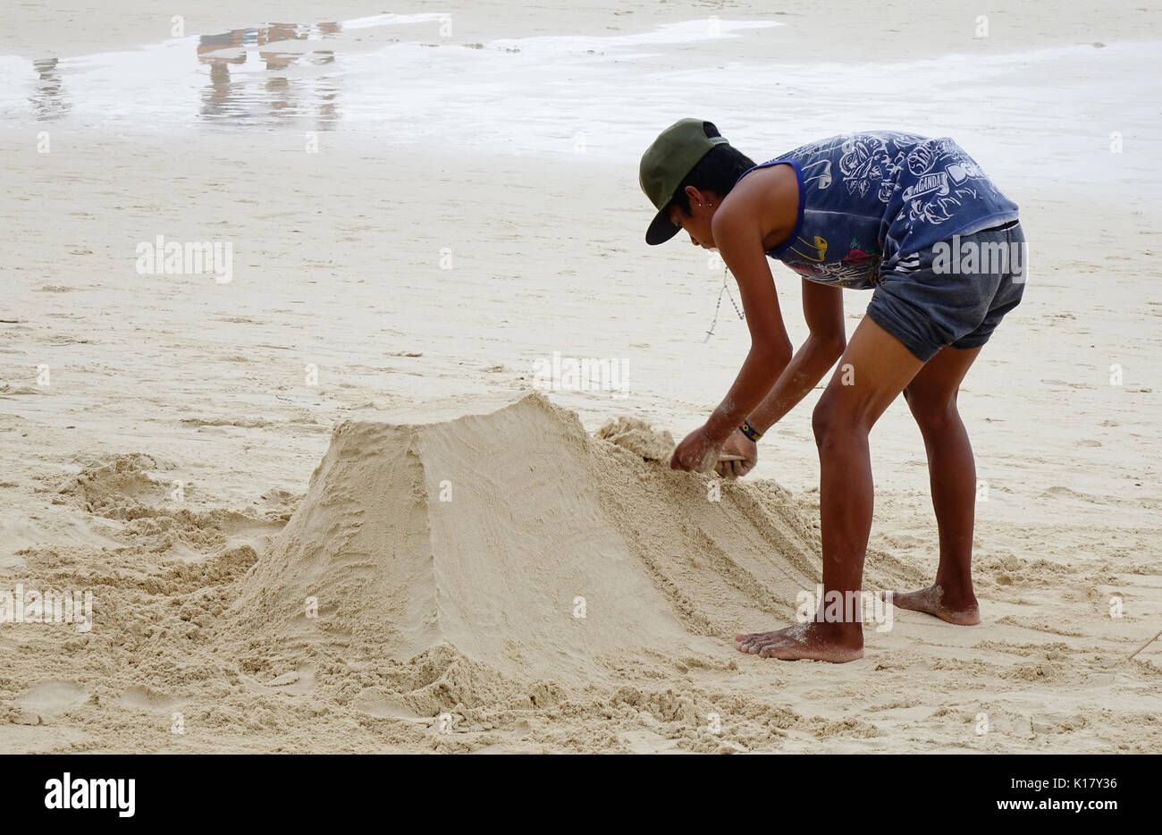 Boracay, Philippines - Dec 17, 2015. A man making sand castle on White ...