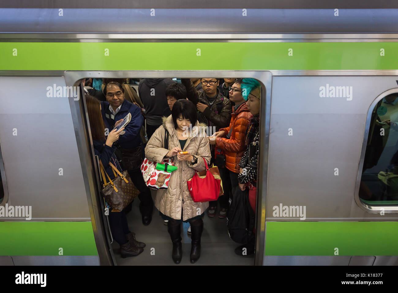 Tokyo, Japan - November 23 2013: Tokyo train is always packed with ...