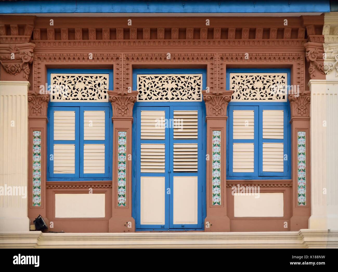 Traditional shop house exterior with blue wooden louvered shutters ...