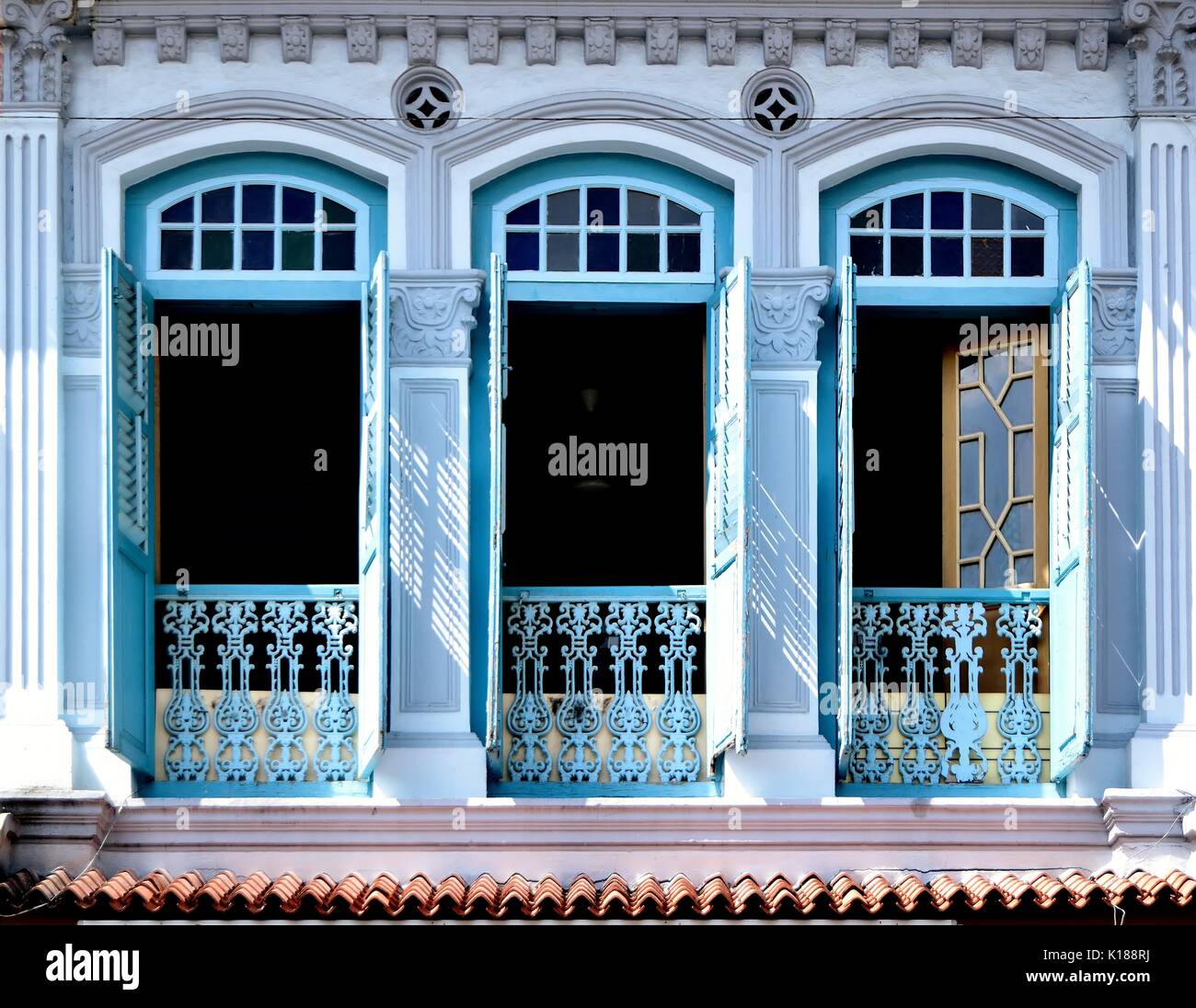 Traditional shop house exterior with blue wooden louvered shutters ...