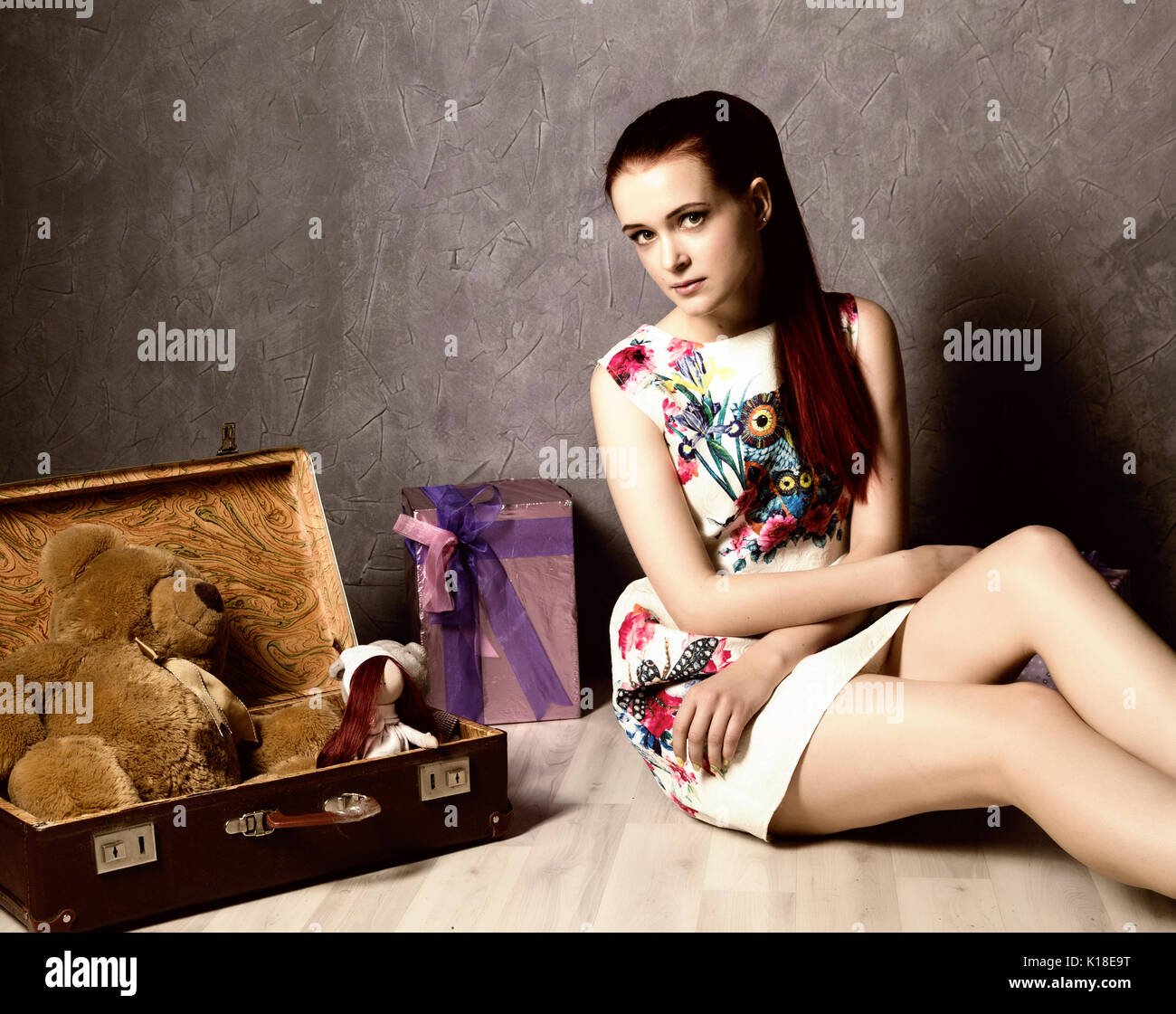 Beautiful young woman packing suitcase and getting ready for traveling ...