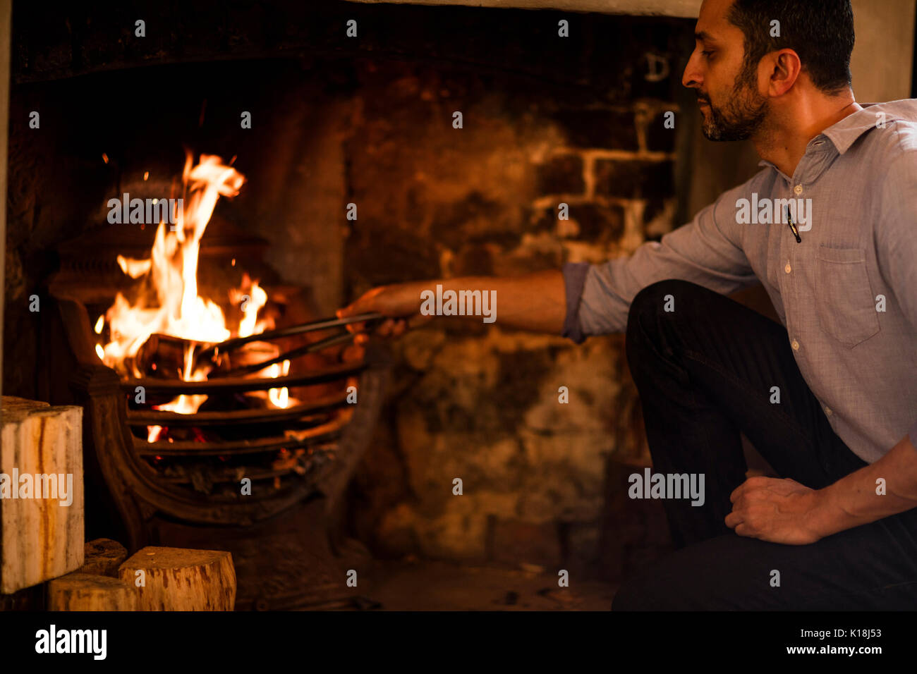 Man stoking fire hi-res stock photography and images - Alamy