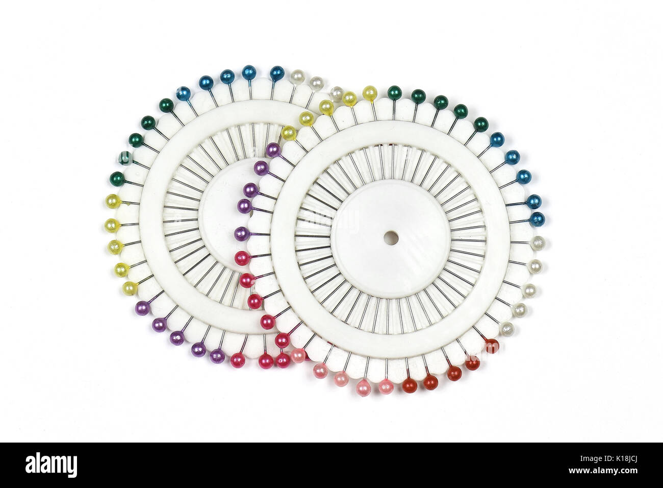 Colorful sewing pins wheel on white background Stock Photo - Alamy