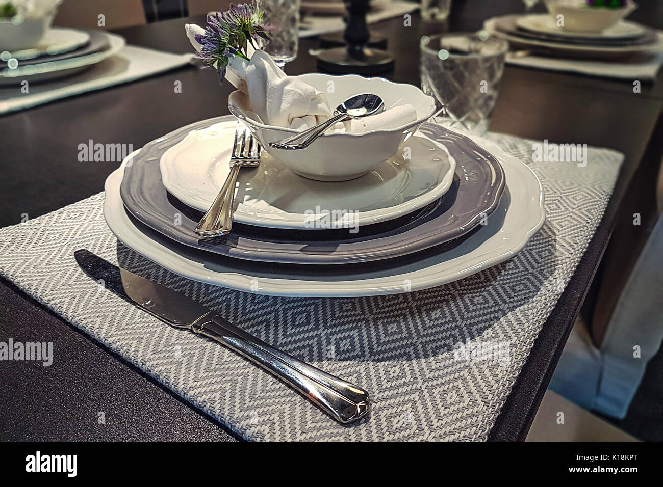 Elegant restaurant table setting with plates cutlery and stemware on a ...