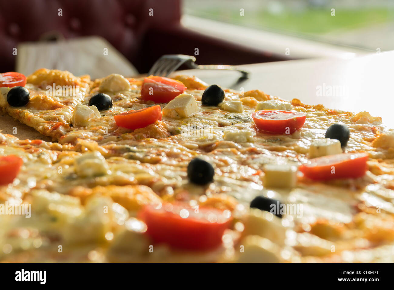 Pizza in cafe. Close up and top view Stock Photo - Alamy
