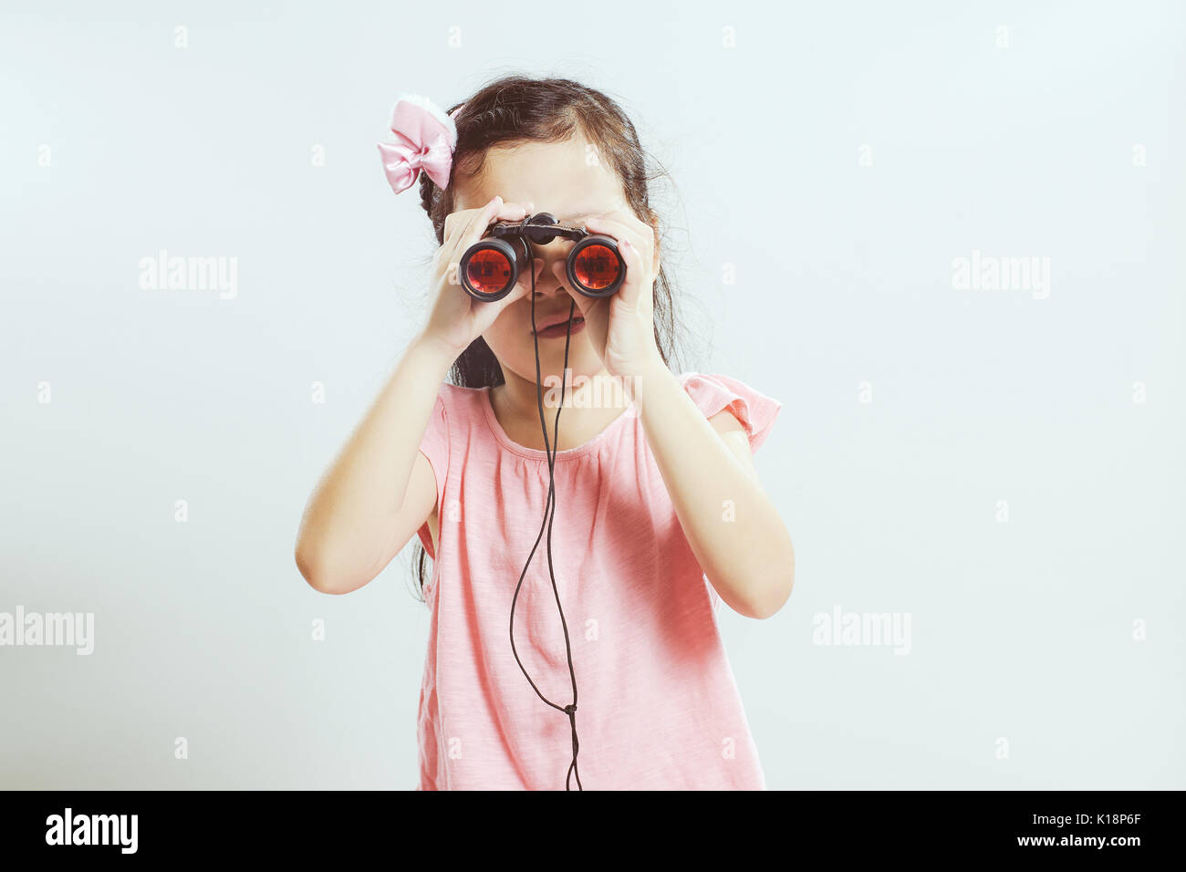 Beautiful little young cute asian girl using telescope looking forward ...
