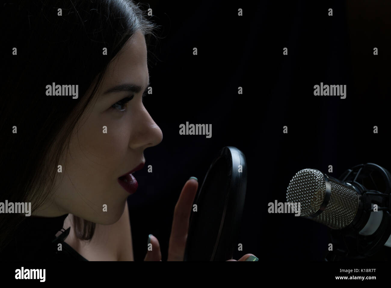 Beautiful girl singing In Recording Studio with microphone Stock Photo ...