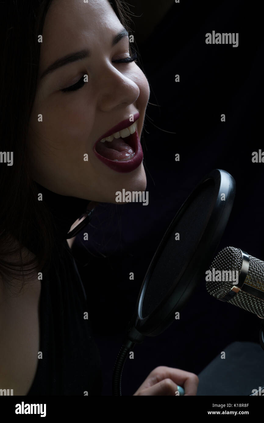 Beautiful girl singing In Recording Studio with microphone Stock Photo ...