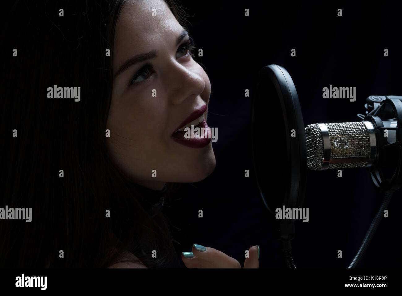 Beautiful girl singing In Recording Studio with microphone Stock Photo ...