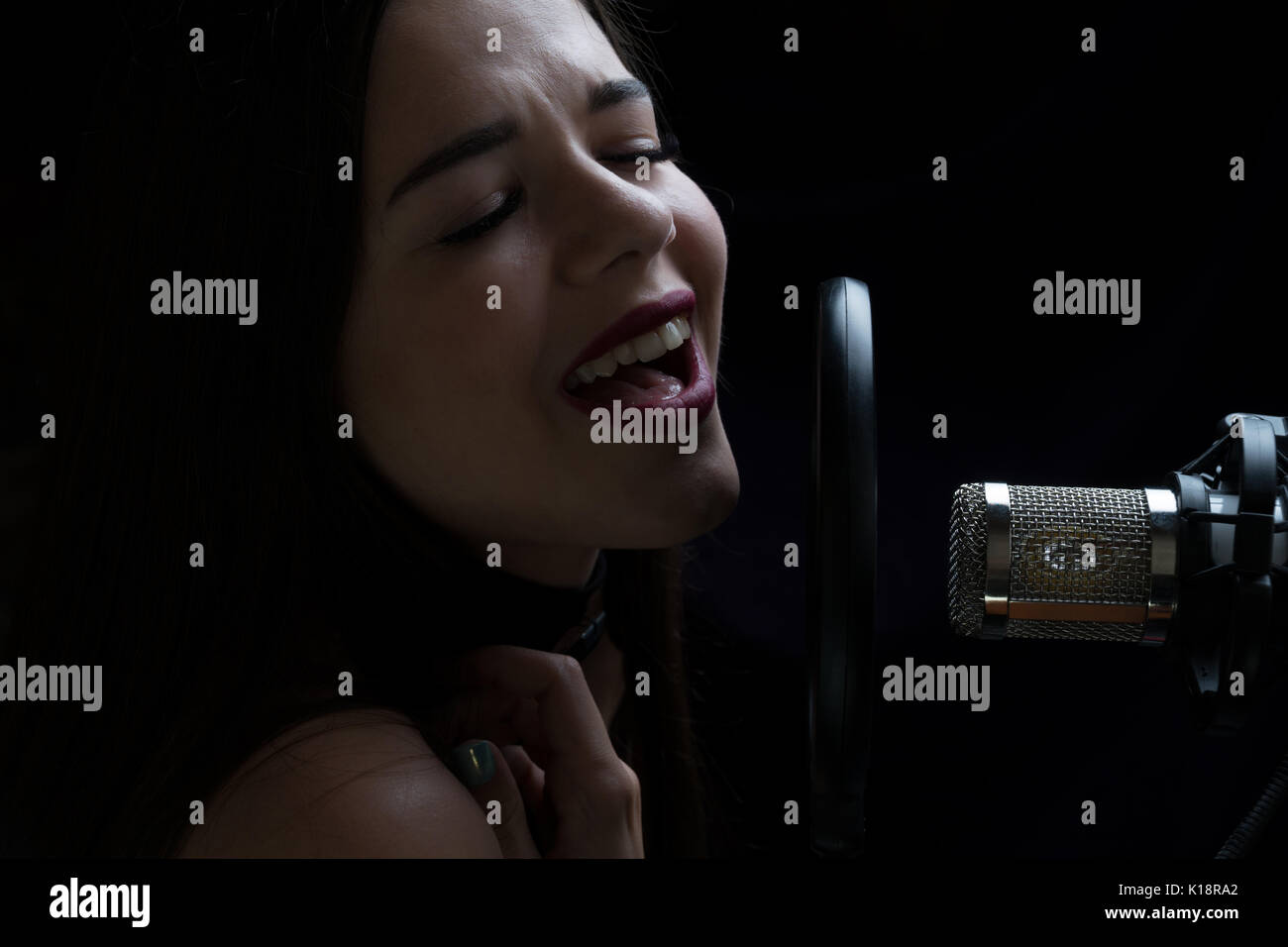 Beautiful girl singing In Recording Studio with microphone Stock Photo ...