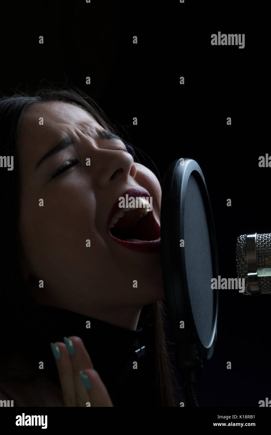 Beautiful girl singing In Recording Studio with microphone Stock Photo ...