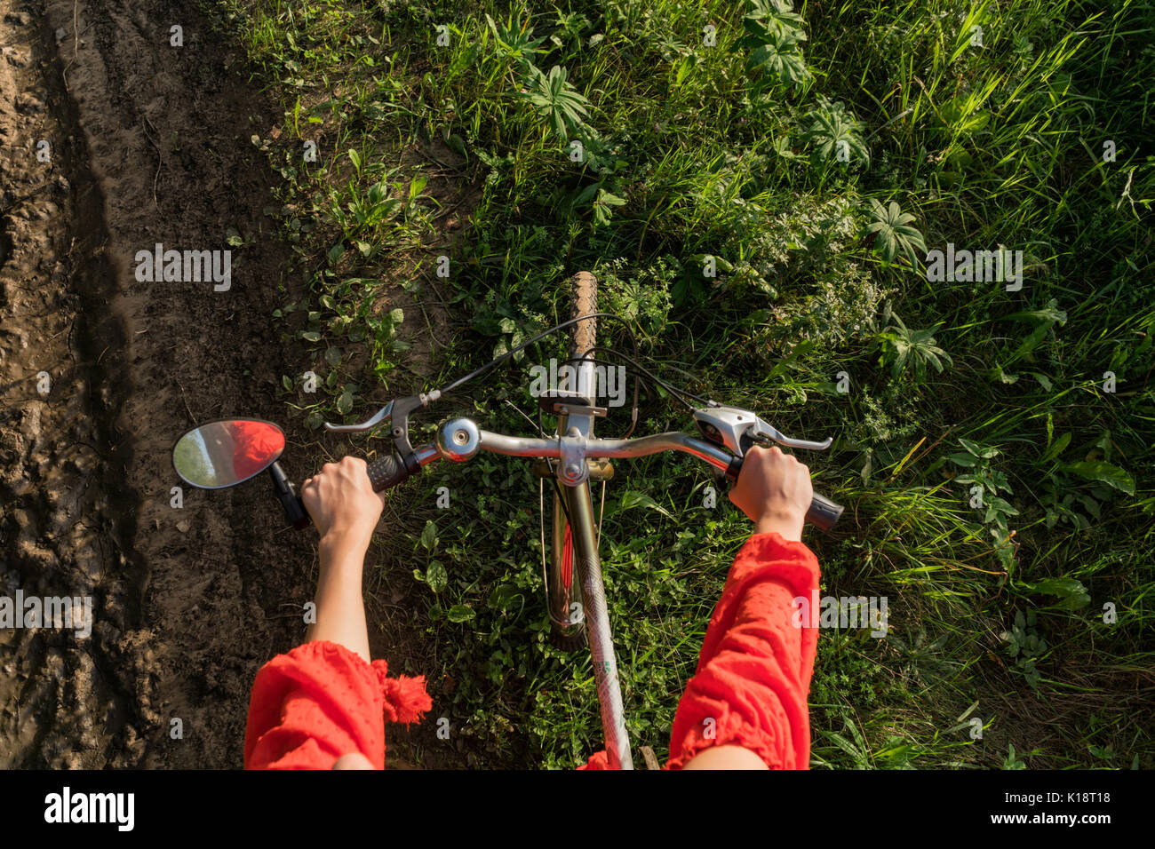 The girl holds onto the wheel of the bicycle. View from above Stock ...