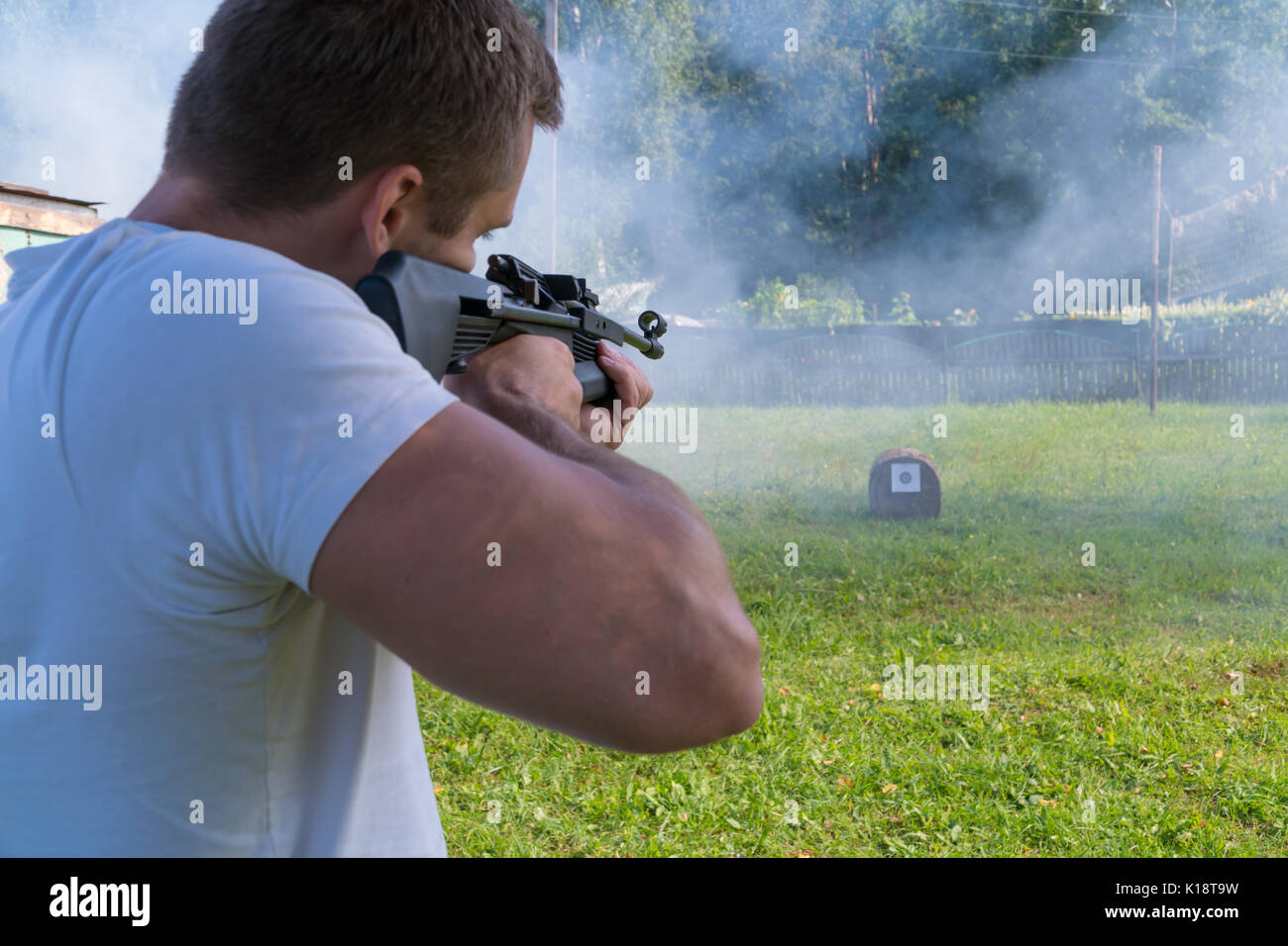 A man shoots a target from a pneumatic gun. Rear view of a man Stock ...