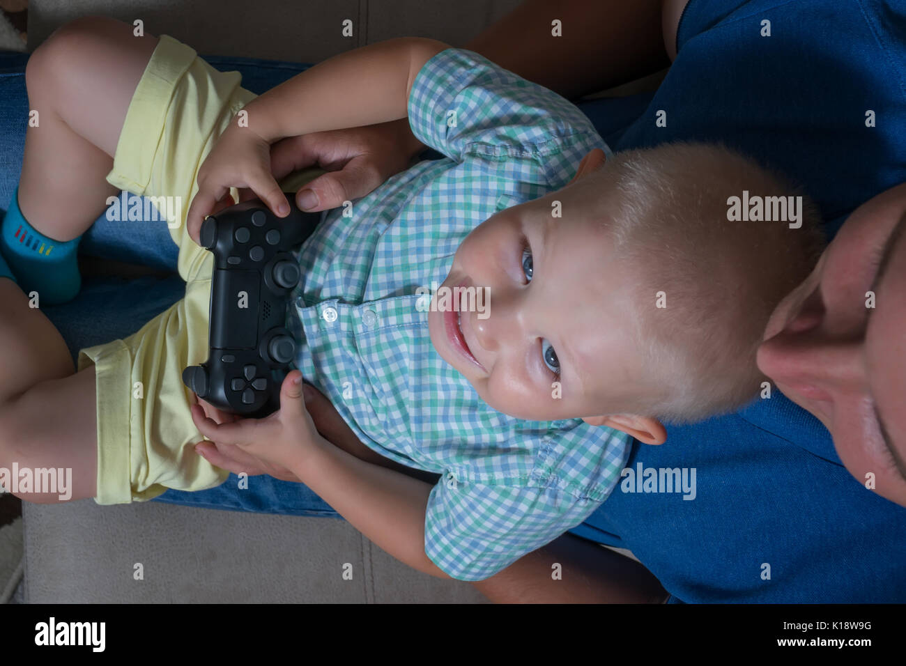 child boy and his father play with a playstation together Stock Photo ...