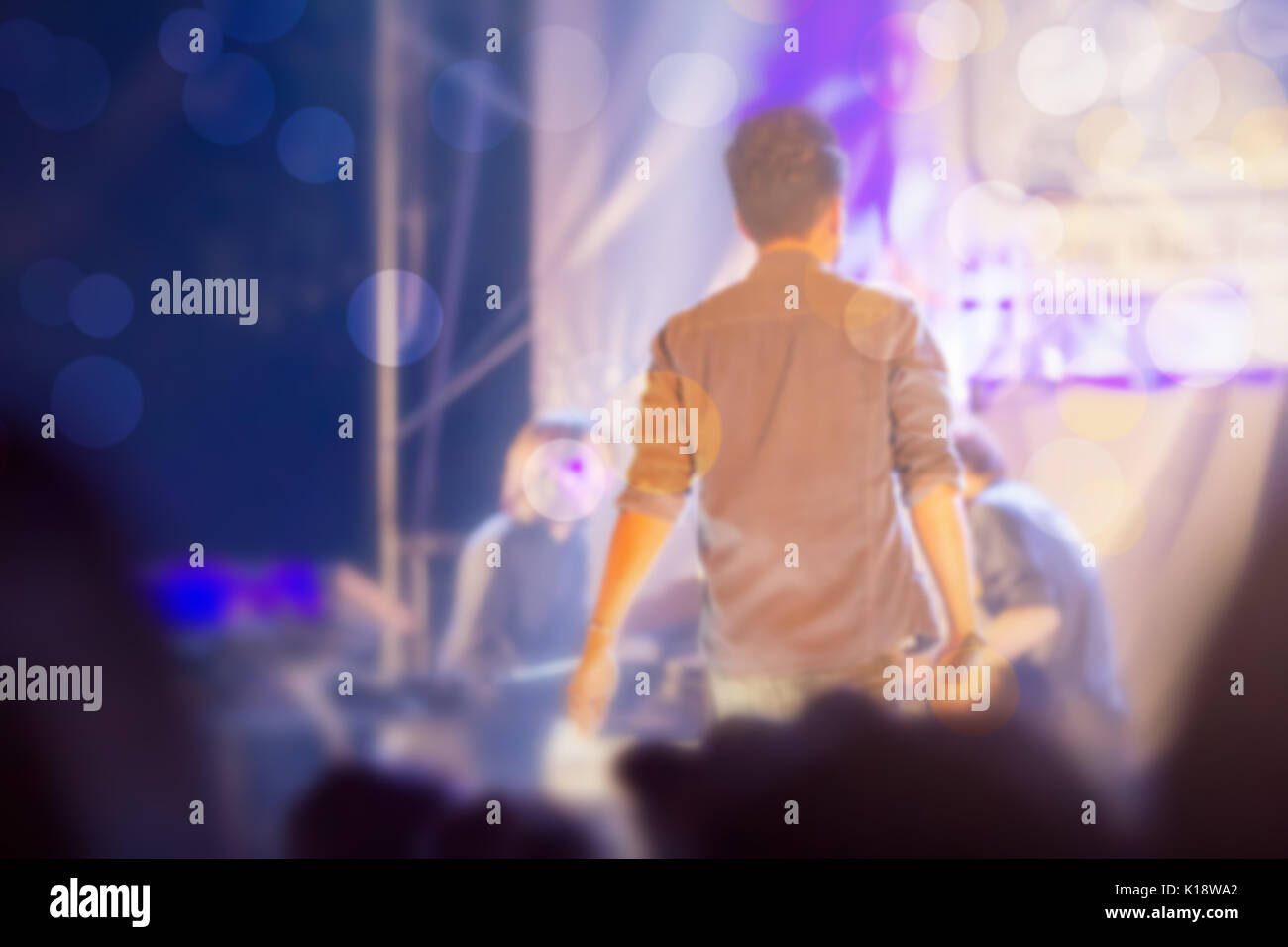 Back view of singer in night concert on stage Stock Photo - Alamy