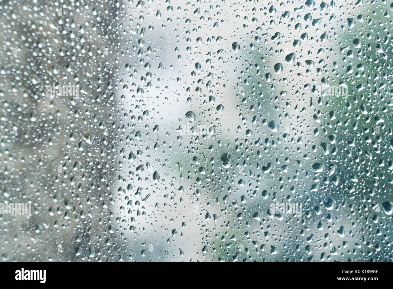 Natural water drop on glass, Background blurred Stock Photo - Alamy
