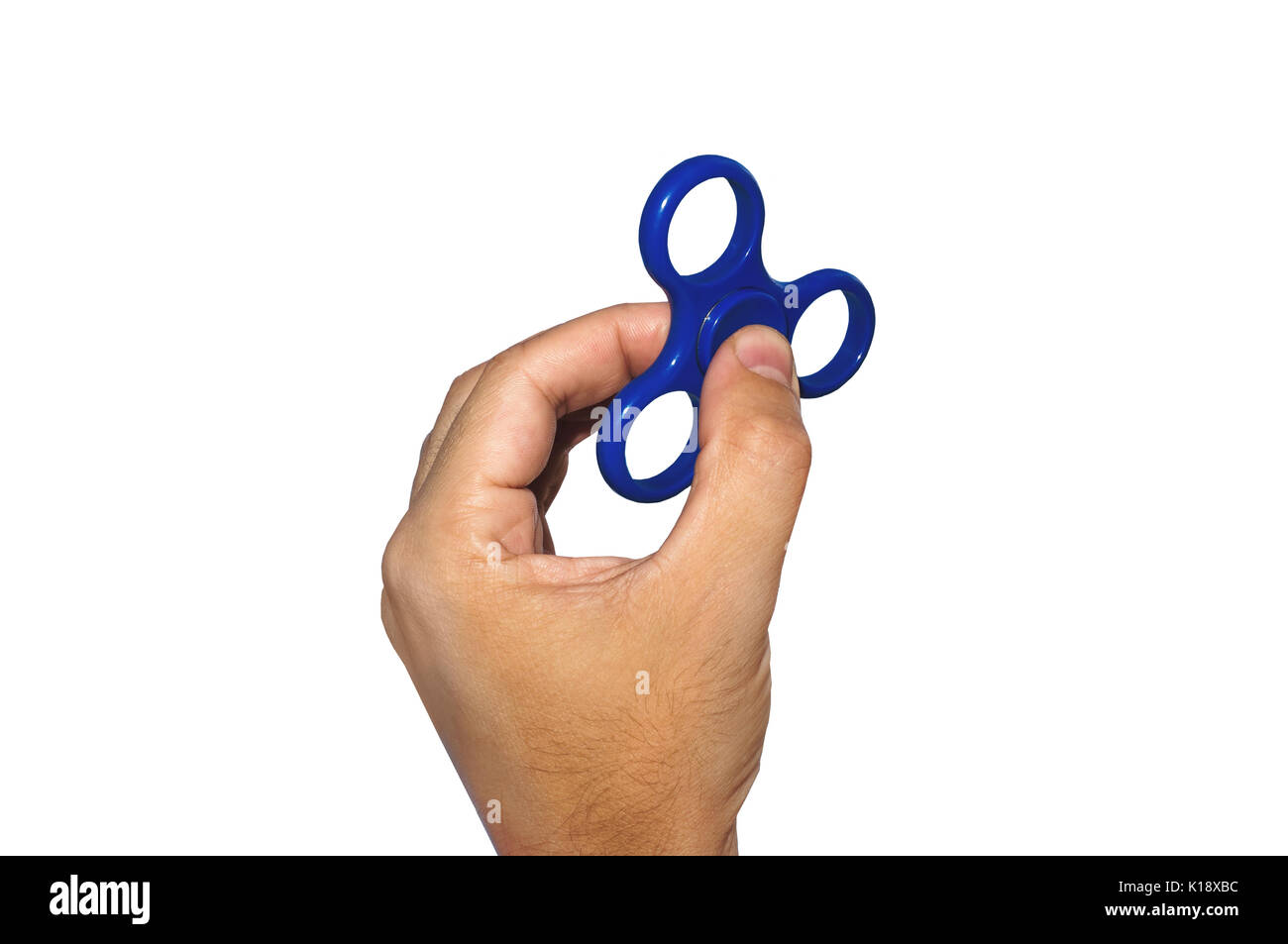 Male hand holding a blue spinner on white isolated background. Powerful ...