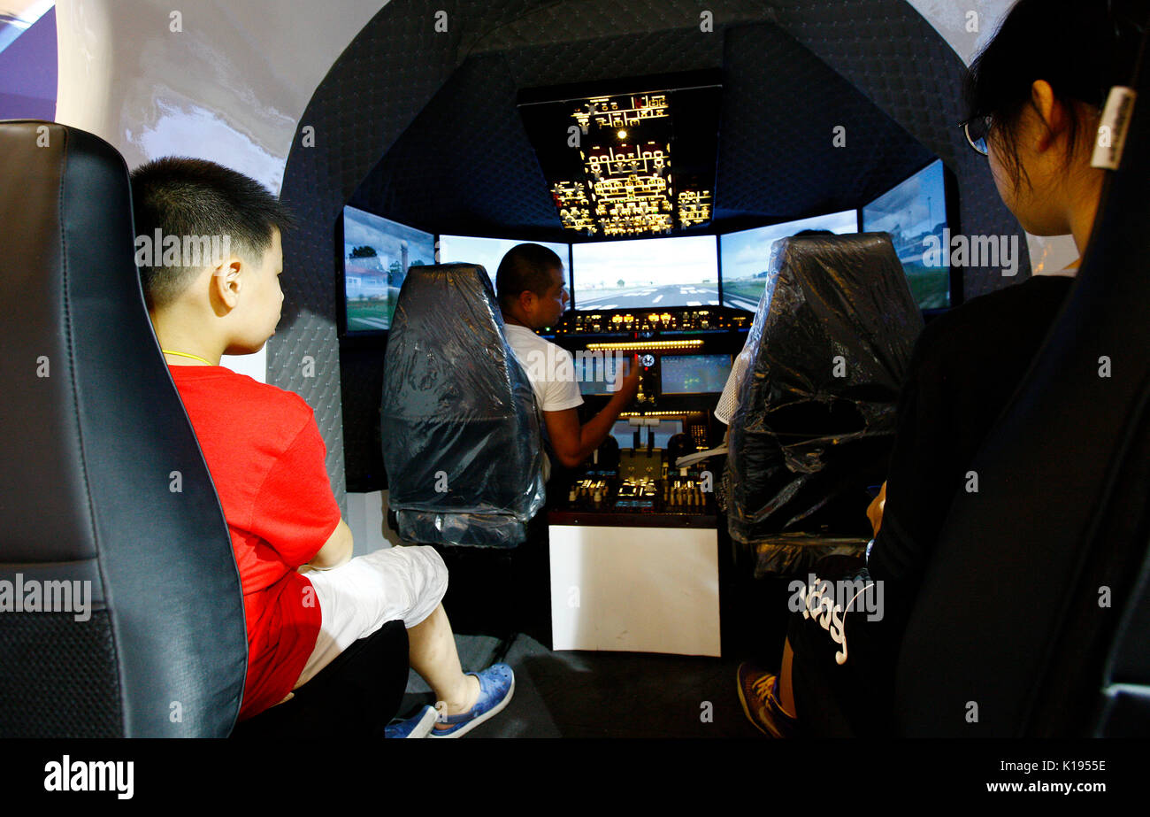 Shanghai, China. 25th Aug, 2017. Visitors experiences a simulator ...