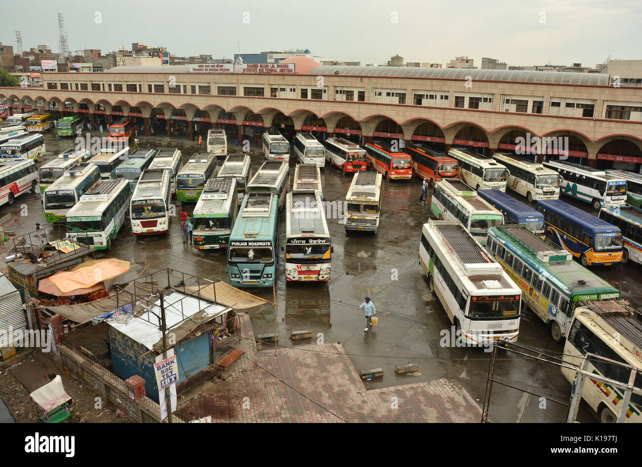 AMRITSAR, INDIA - AUGUST 25: Buses stand parked at a bus stand in ...