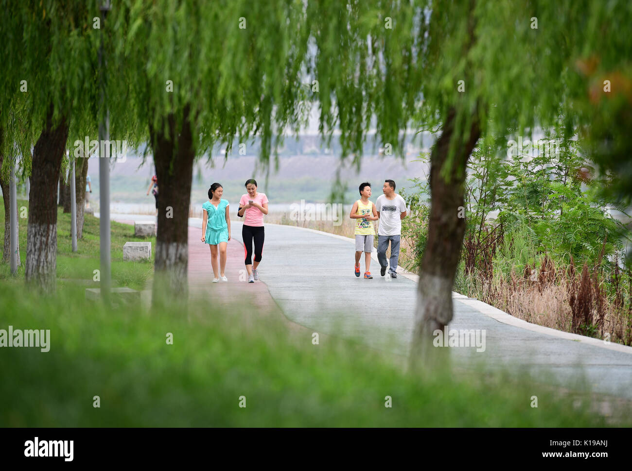 Ankang, China's Shaanxi Province. 26th Aug, 2017. People walk on a ...
