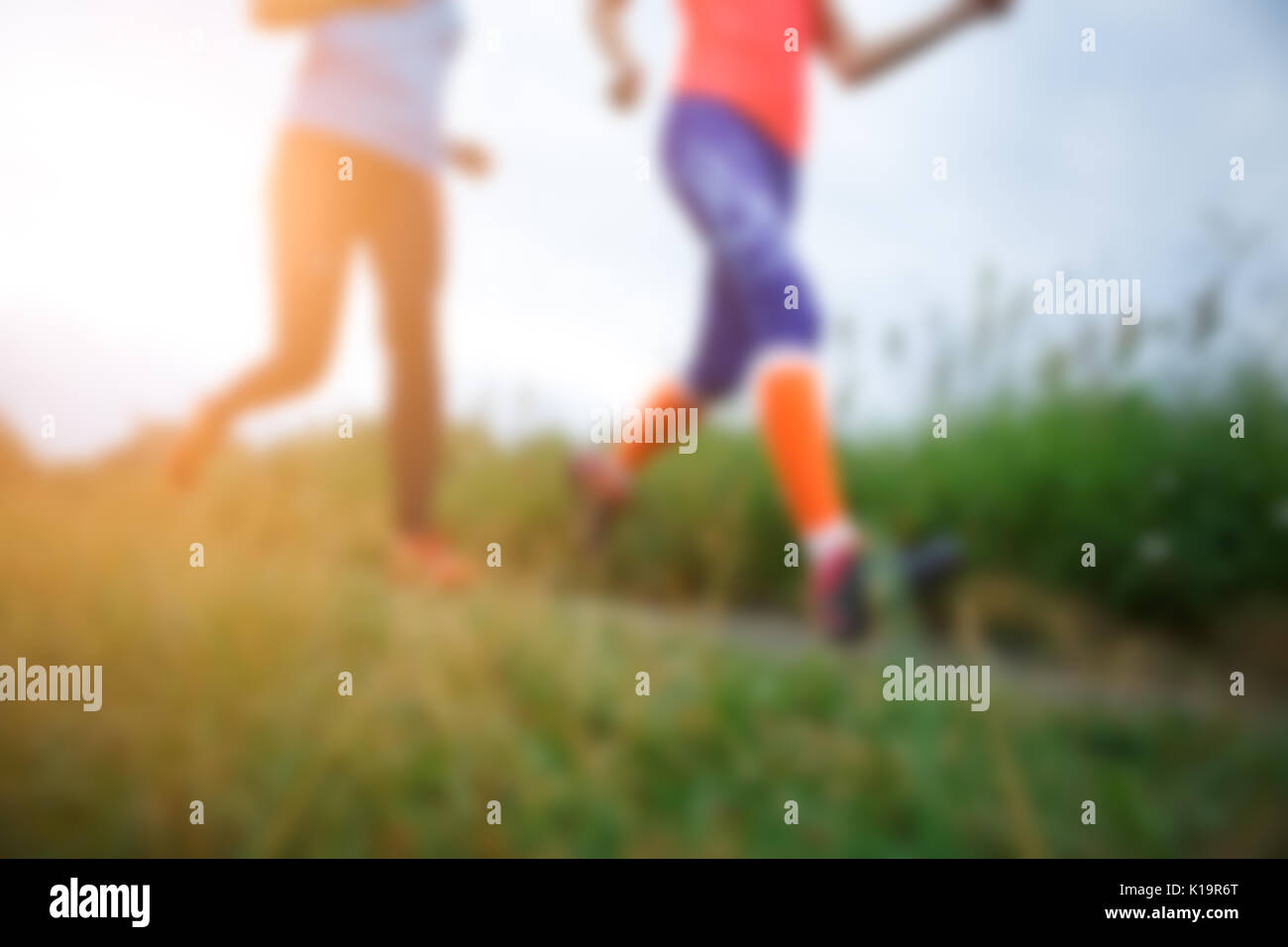 Blurred photo from below of two running girls in forest Stock Photo - Alamy