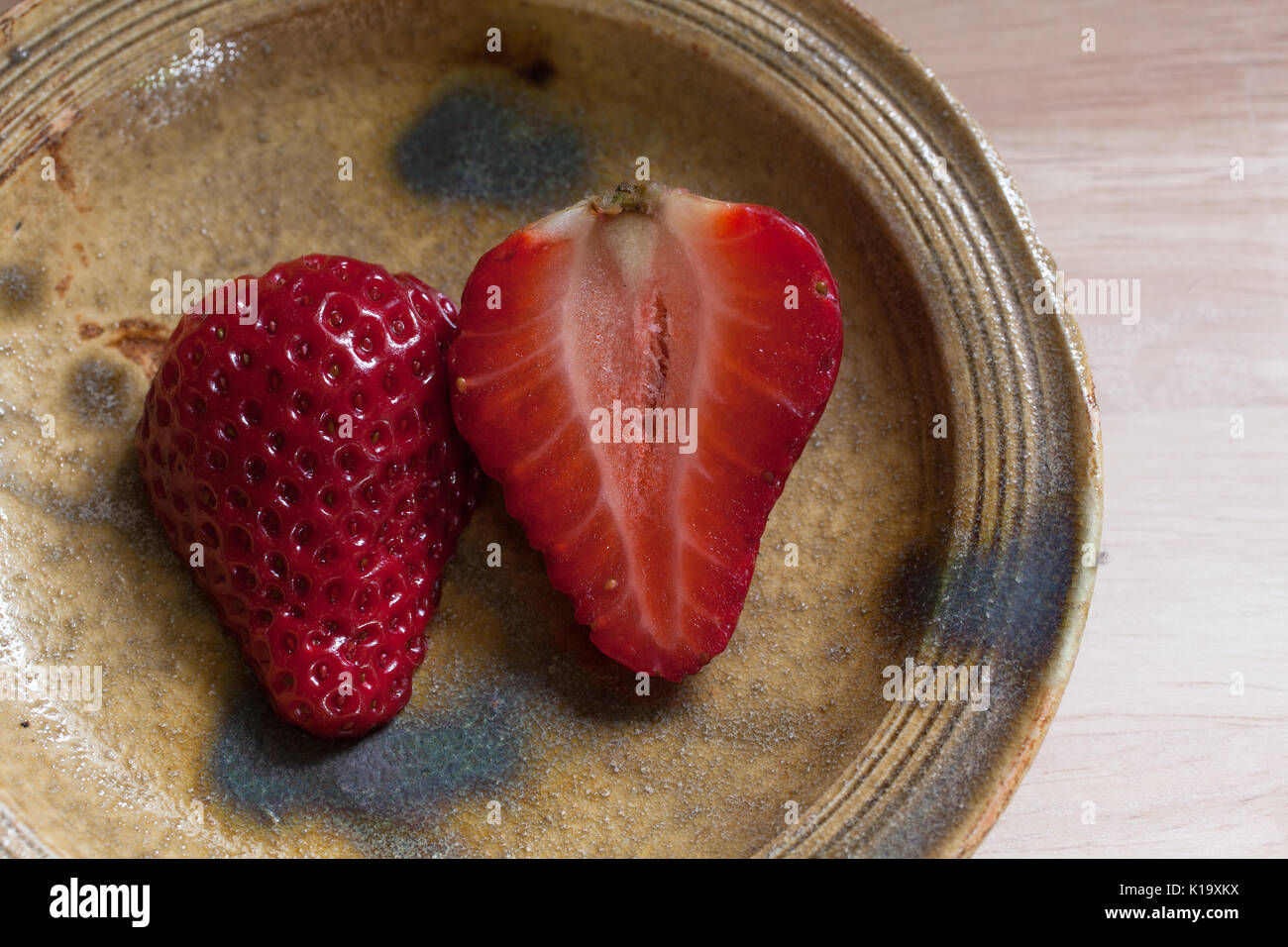 cutting strawberry on vintage dish Stock Photo - Alamy