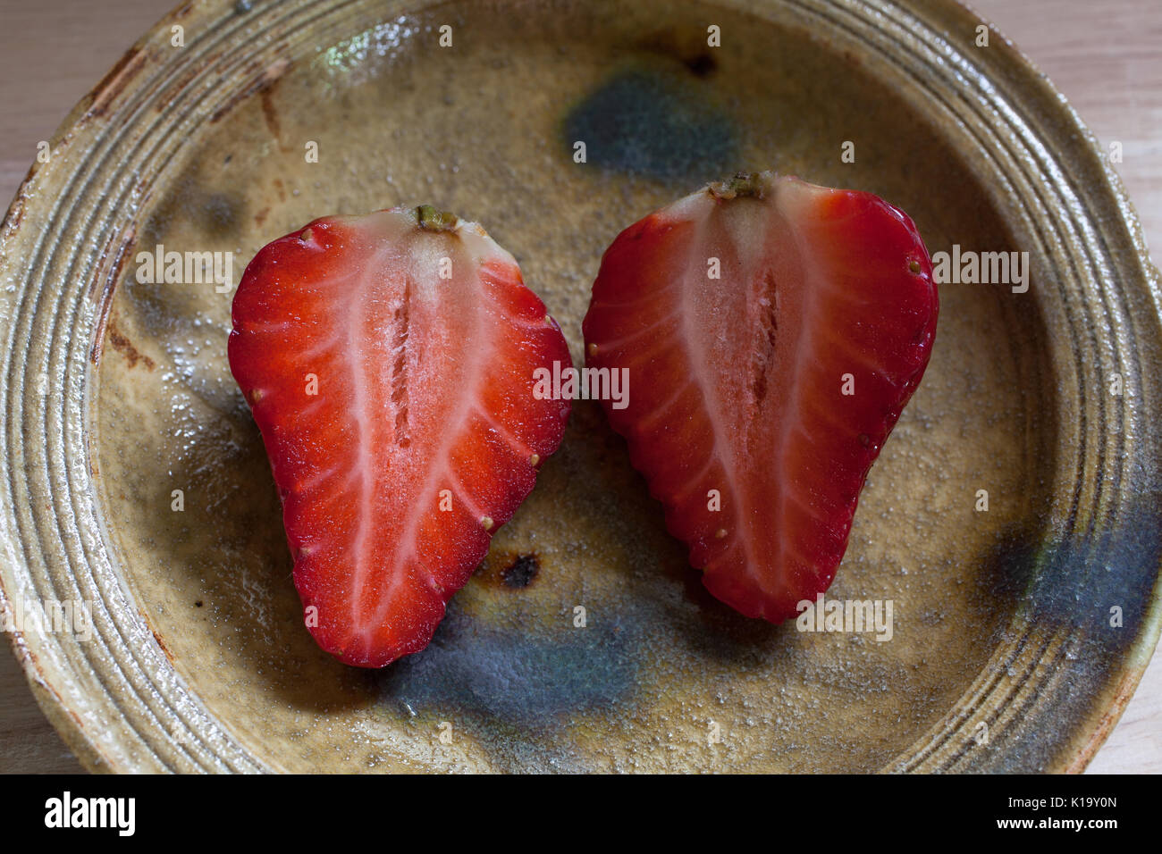 cutting strawberry on vintage dish Stock Photo - Alamy