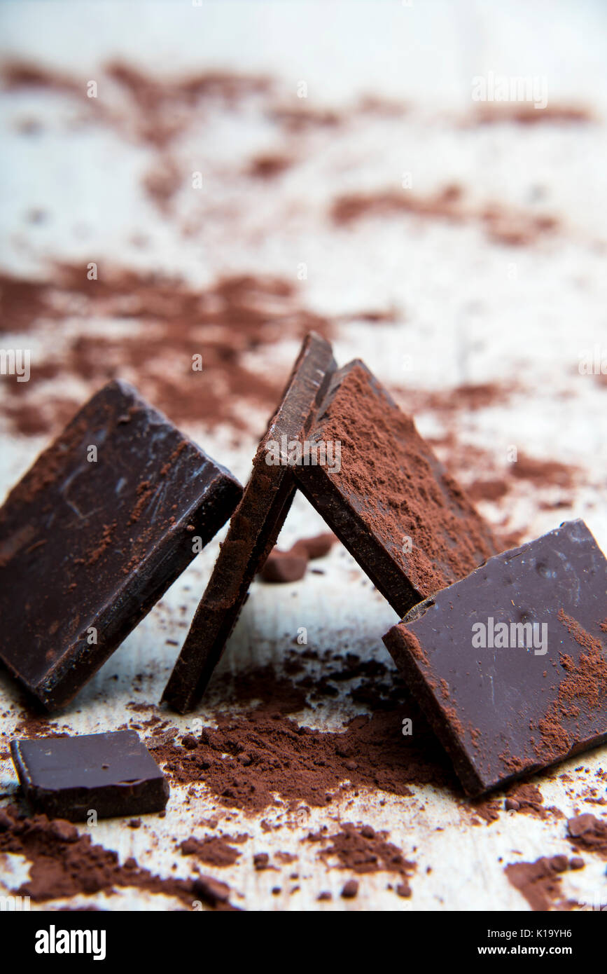 Chocolate structure covered with cocoa powder on wood textured table ...