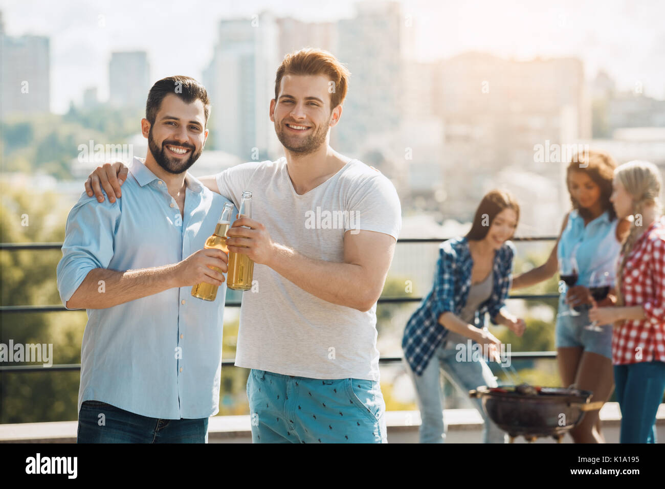 Group of people having barbecue party drinking beer Stock Photo - Alamy