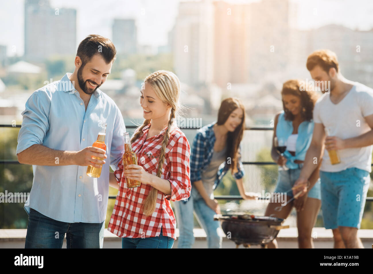 Group of people having barbecue party drinking beer Stock Photo - Alamy