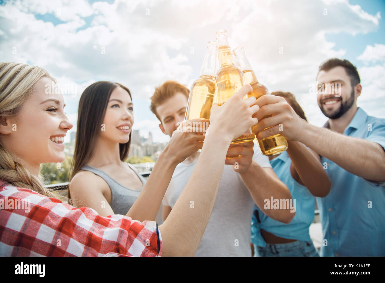 Group of people having barbecue party drinking beer Stock Photo - Alamy