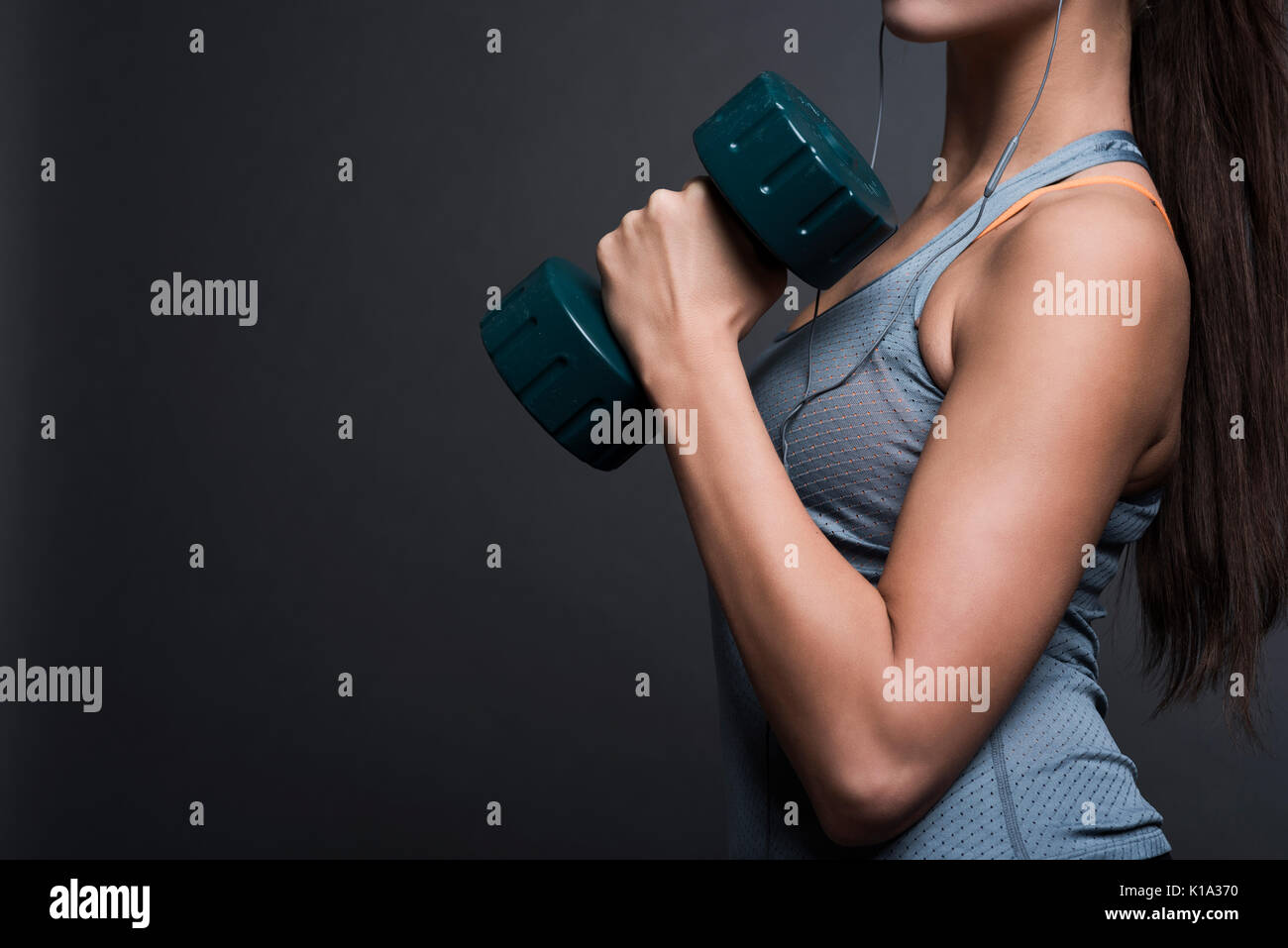 Strong woman carrying heavy dumbbell Stock Photo - Alamy