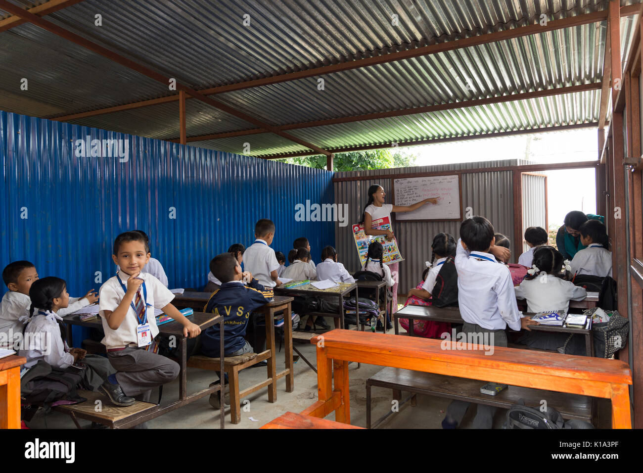 School children in the rural town of Dhulikhel enjoying a lesson from ...