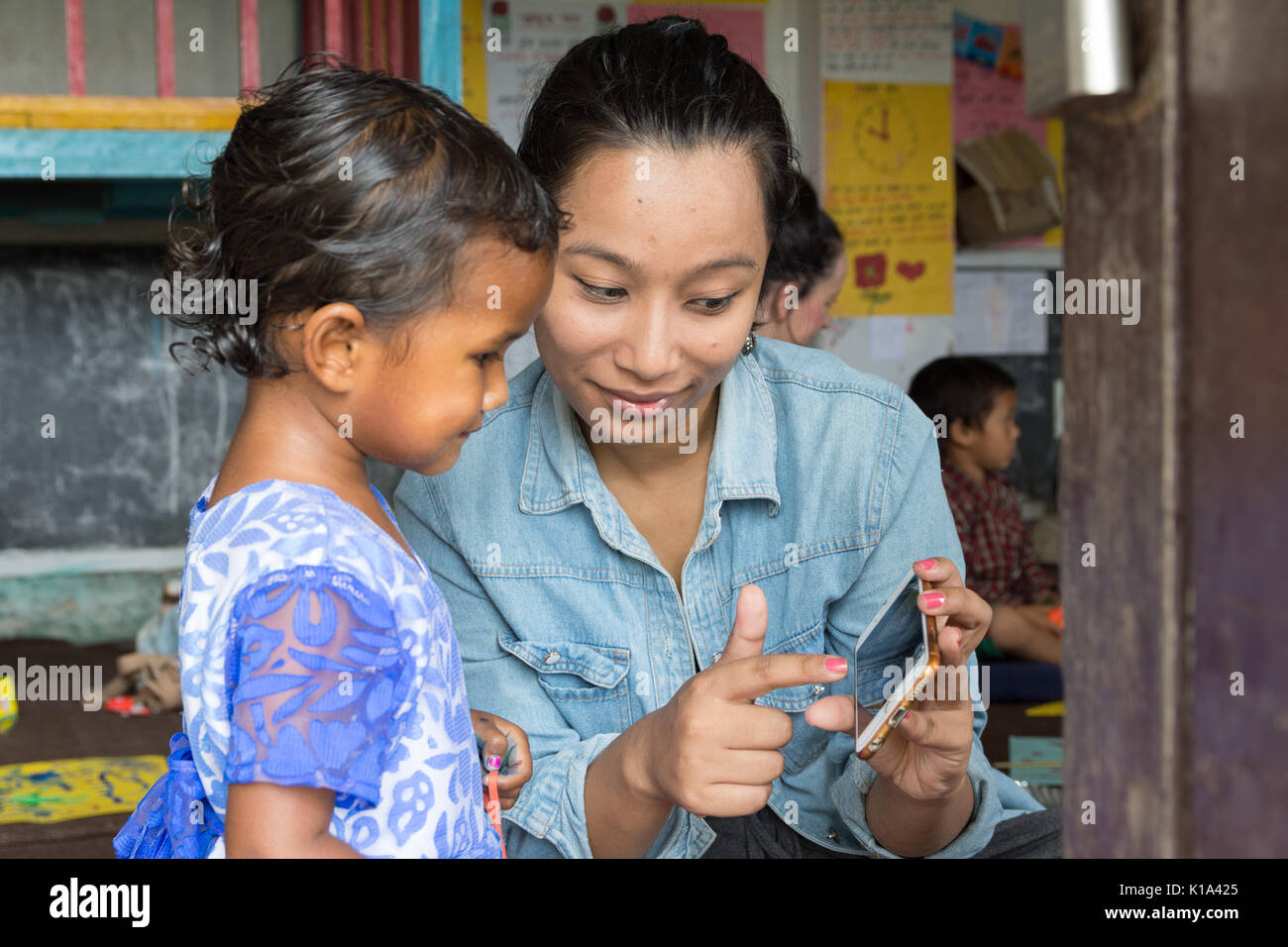 School children in the rural town of Dhulikhel enjoying a lesson from ...