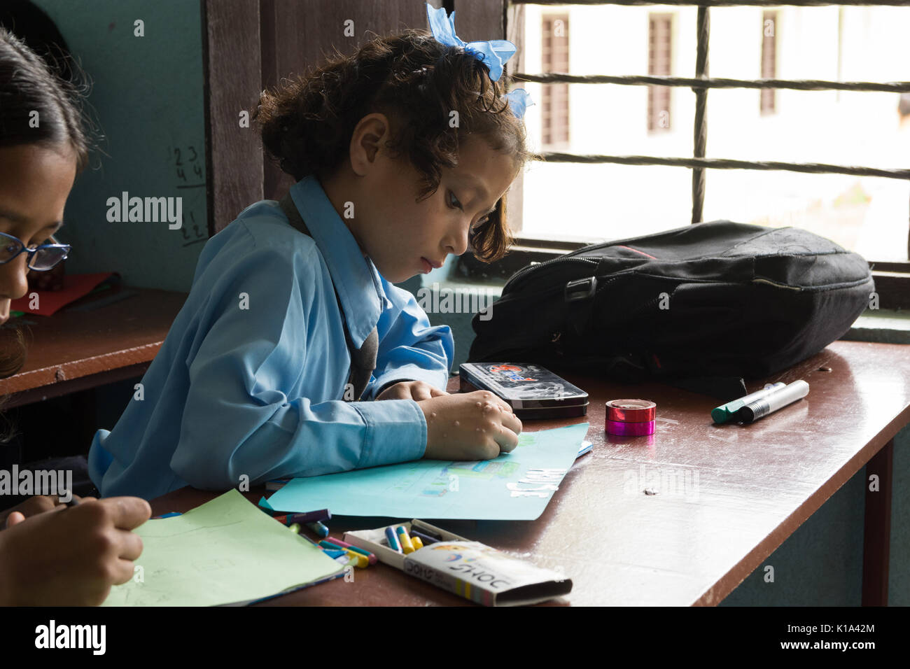 School children in the rural town of Dhulikhel enjoying a lesson from ...